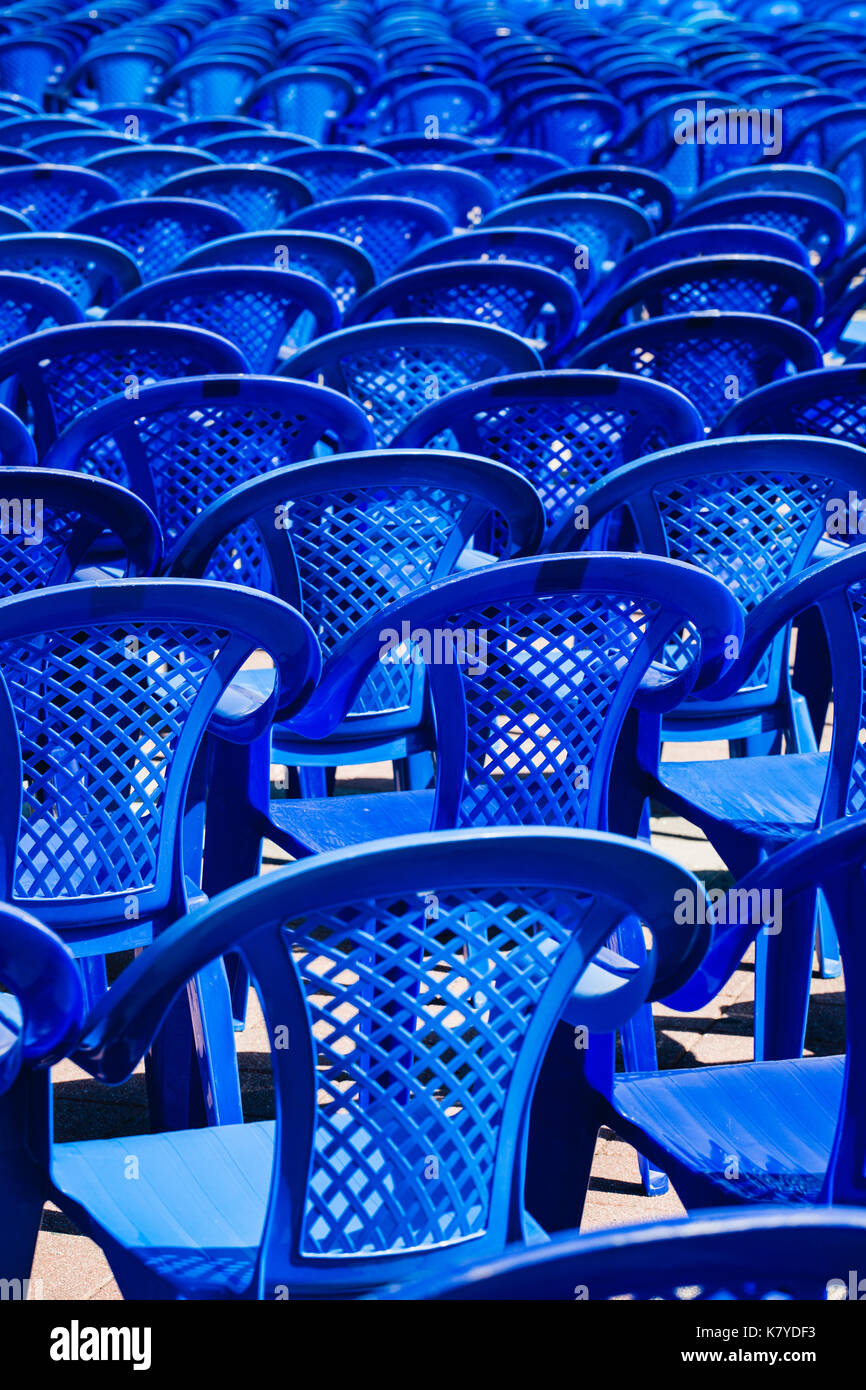 Bright plastic chairs standing in a row Stock Photo - Alamy