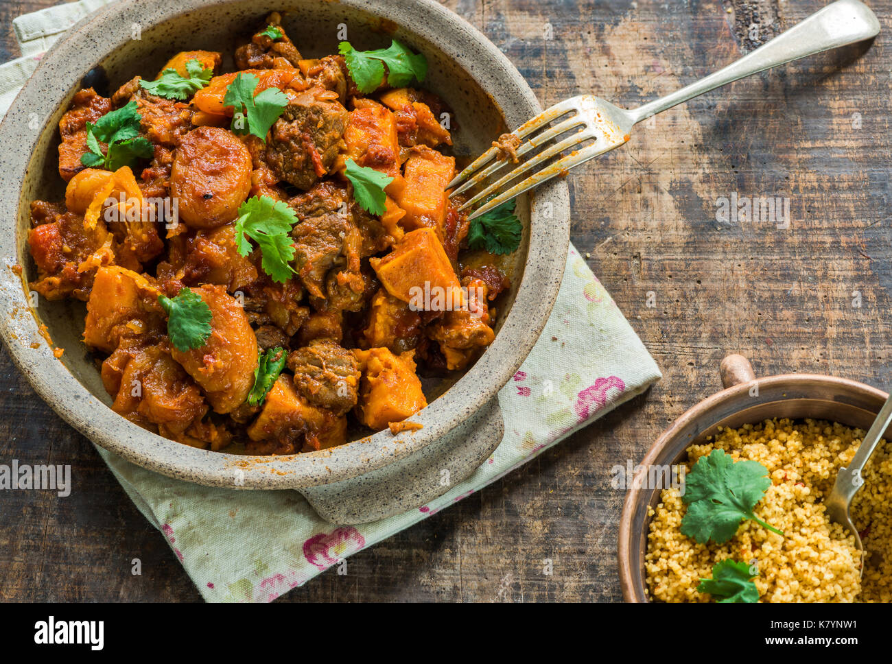 Maroccan lamb tajine with couscous garnished with fresh coriander ...