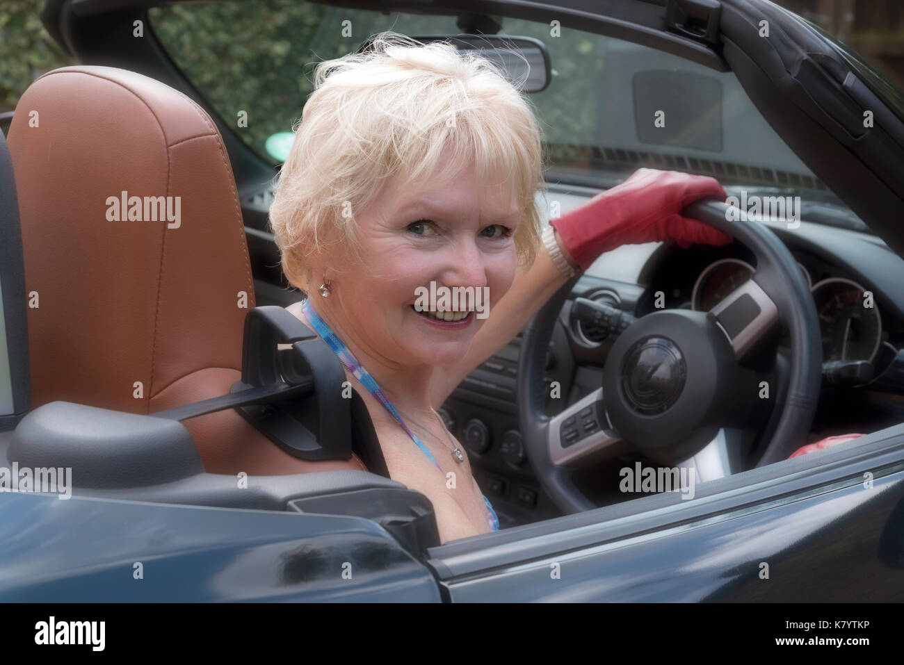 Elderly woman driving a sports car Stock Photo - Alamy