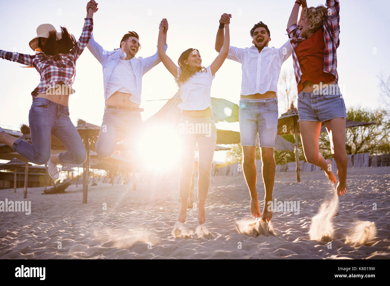 Happy group of young people having fun at beach Stock Photo - Alamy