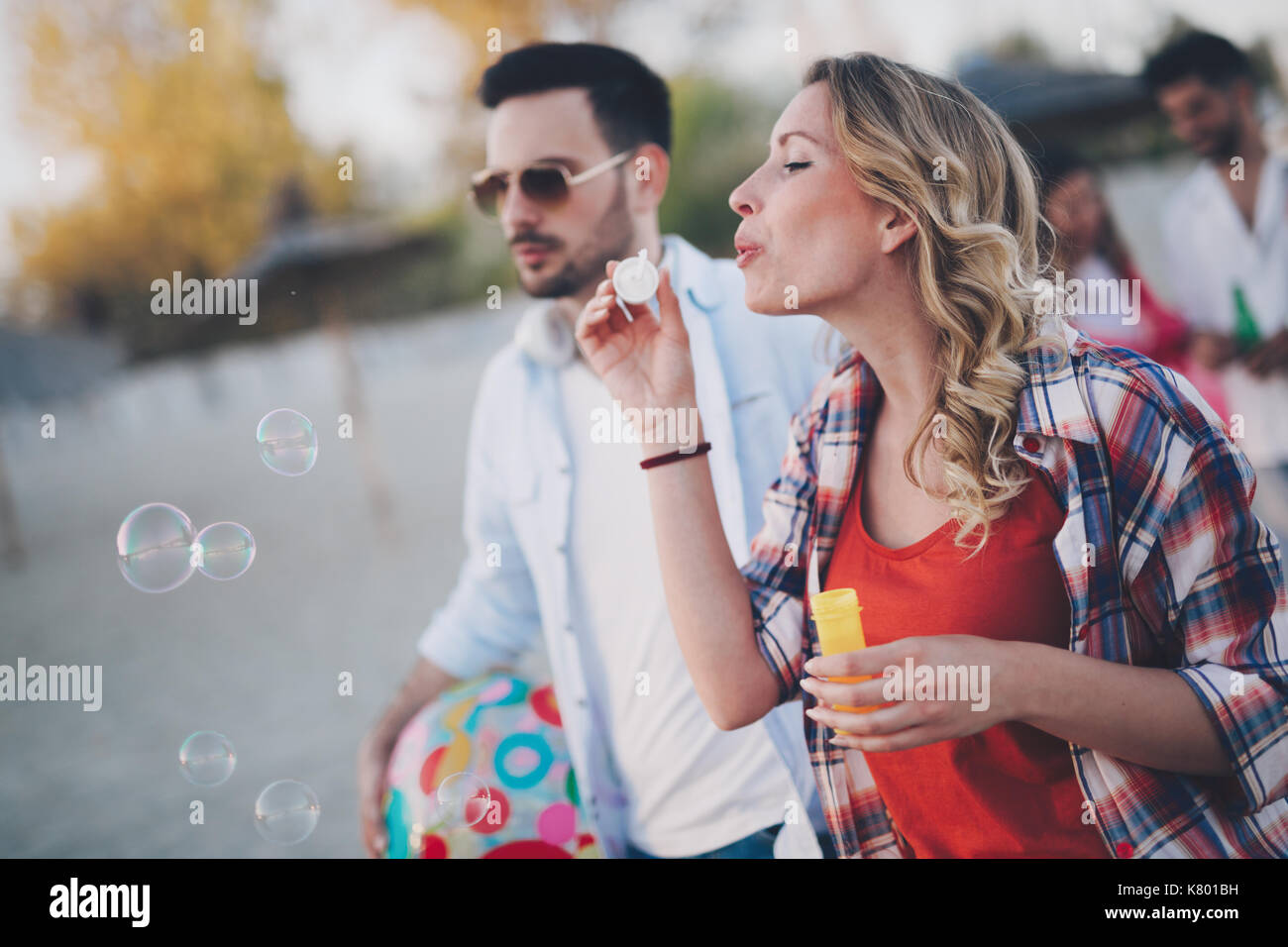 Group of happy friends partying on beach Stock Photo - Alamy
