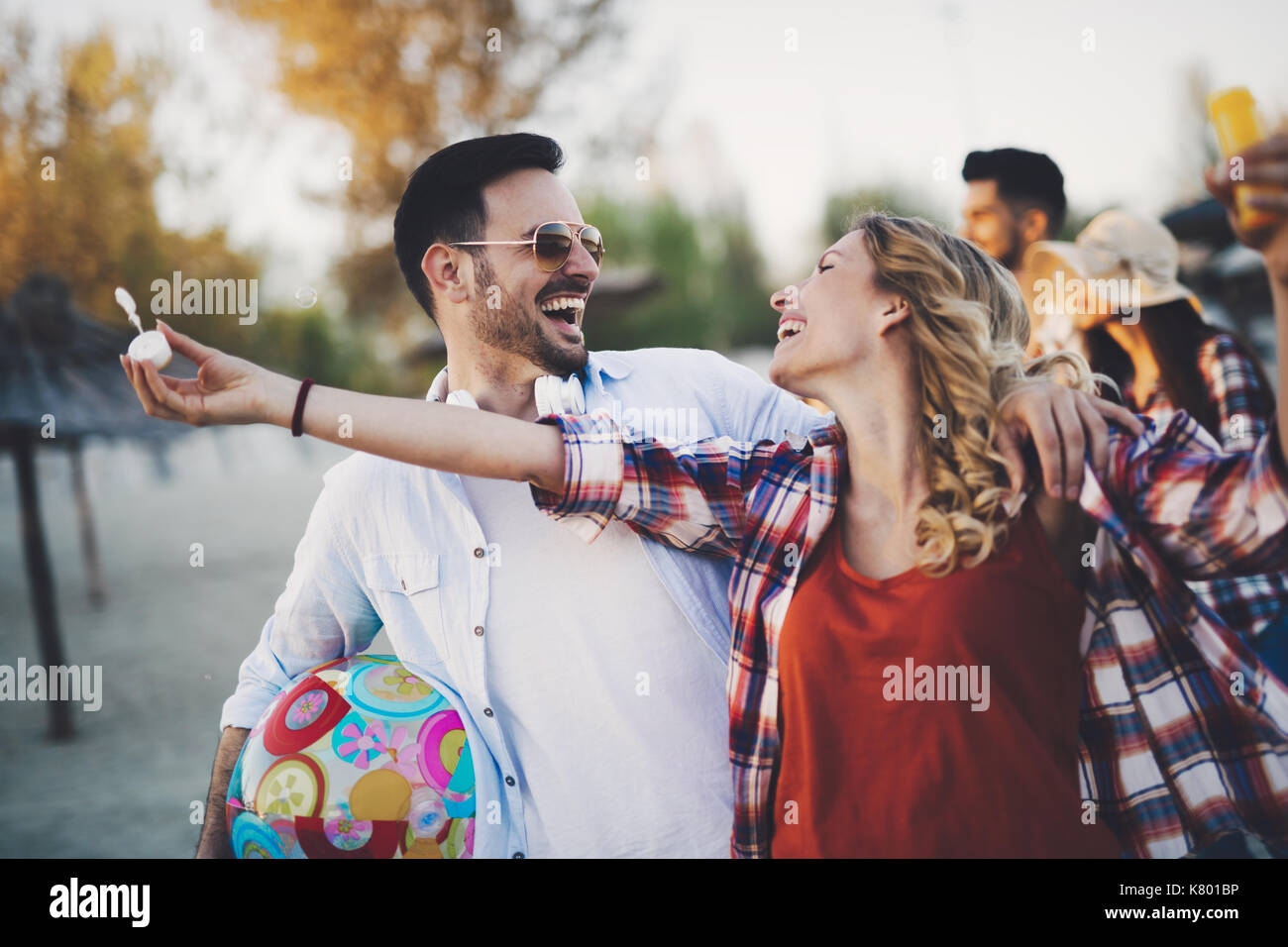 Group of happy friends partying on beach Stock Photo - Alamy
