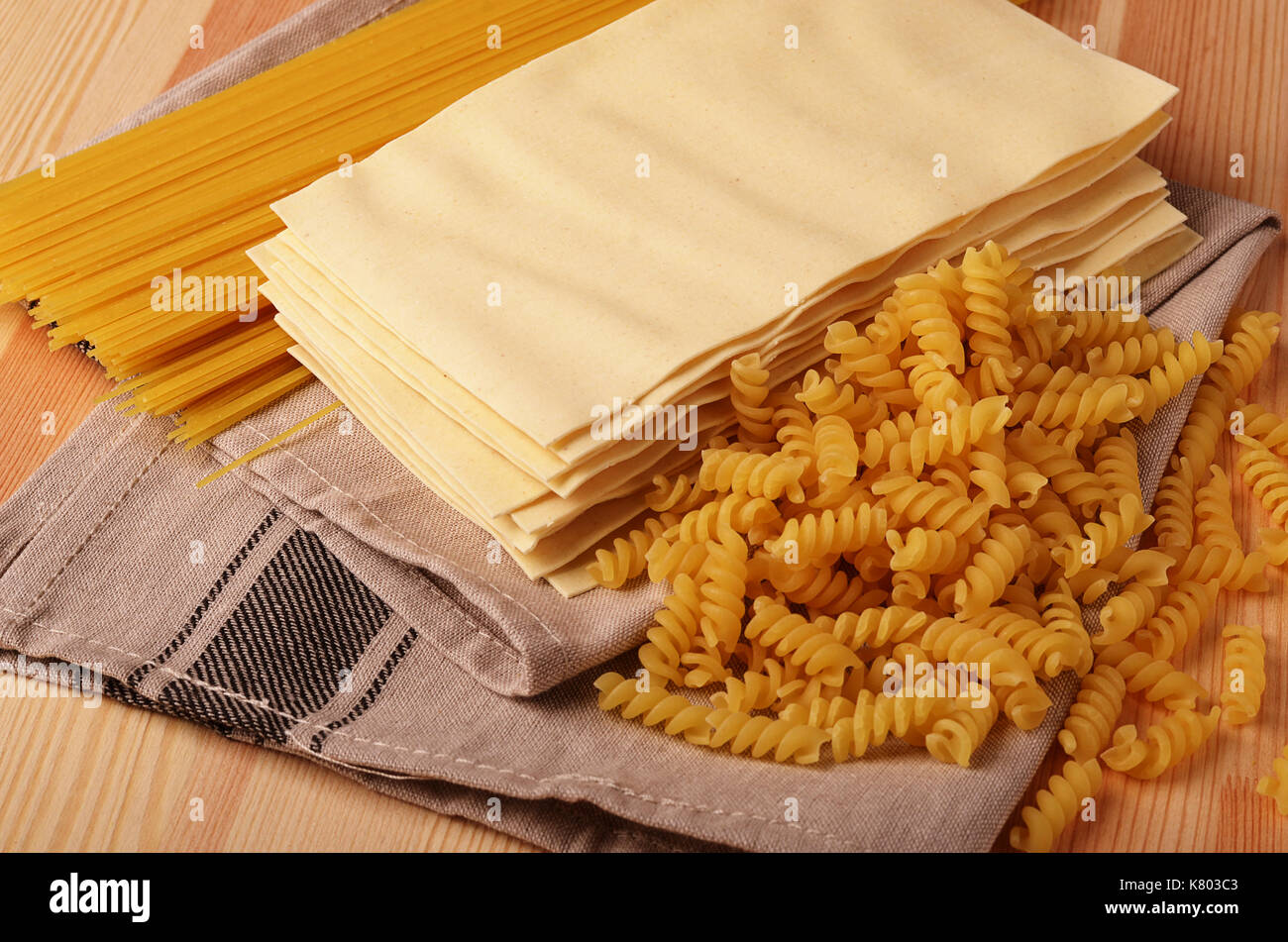 Assorted types of pasta on wooden background. Various forms of pasta ...