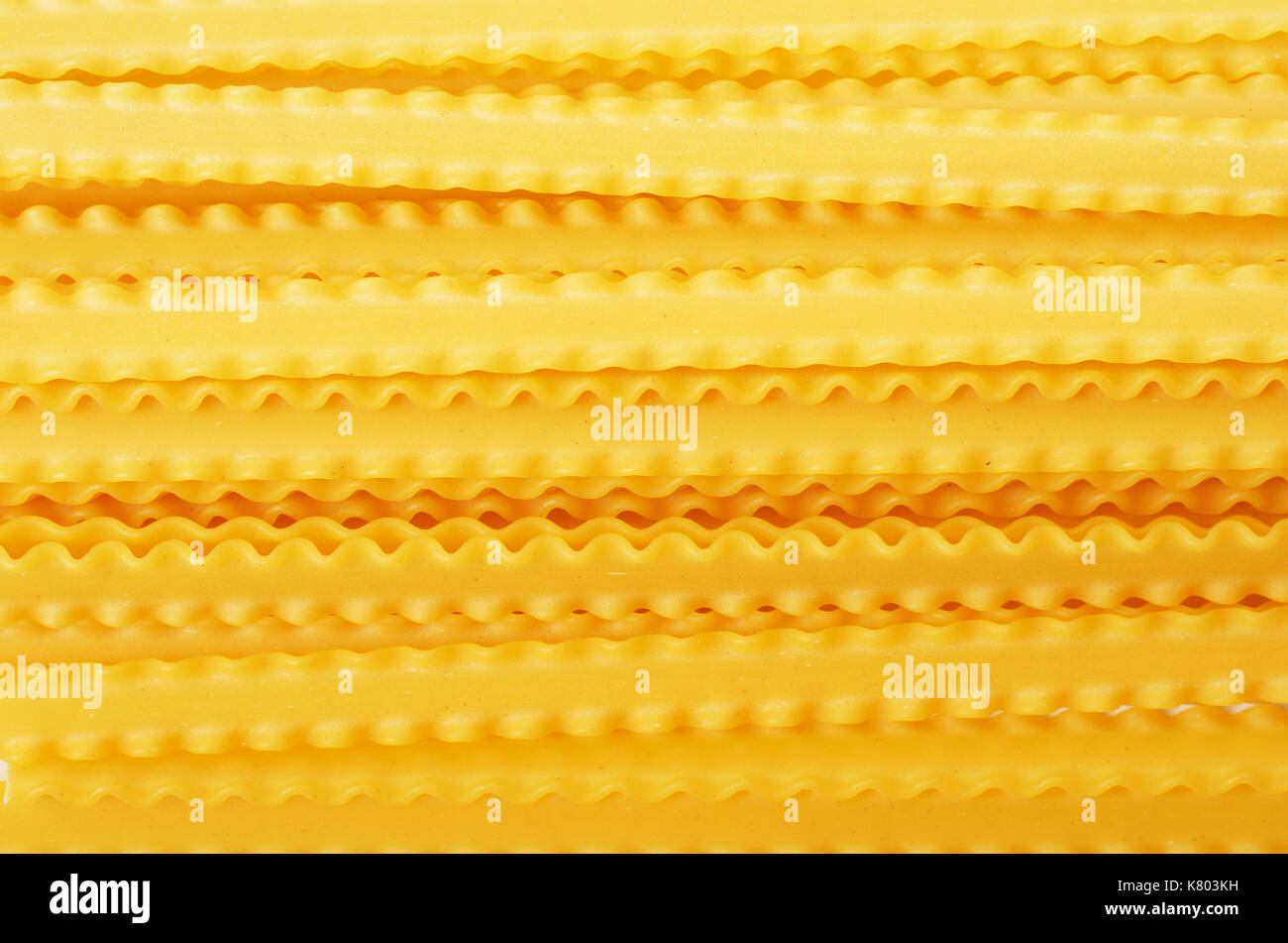 Yellow long wavy spaghetti pasta as background Stock Photo - Alamy
