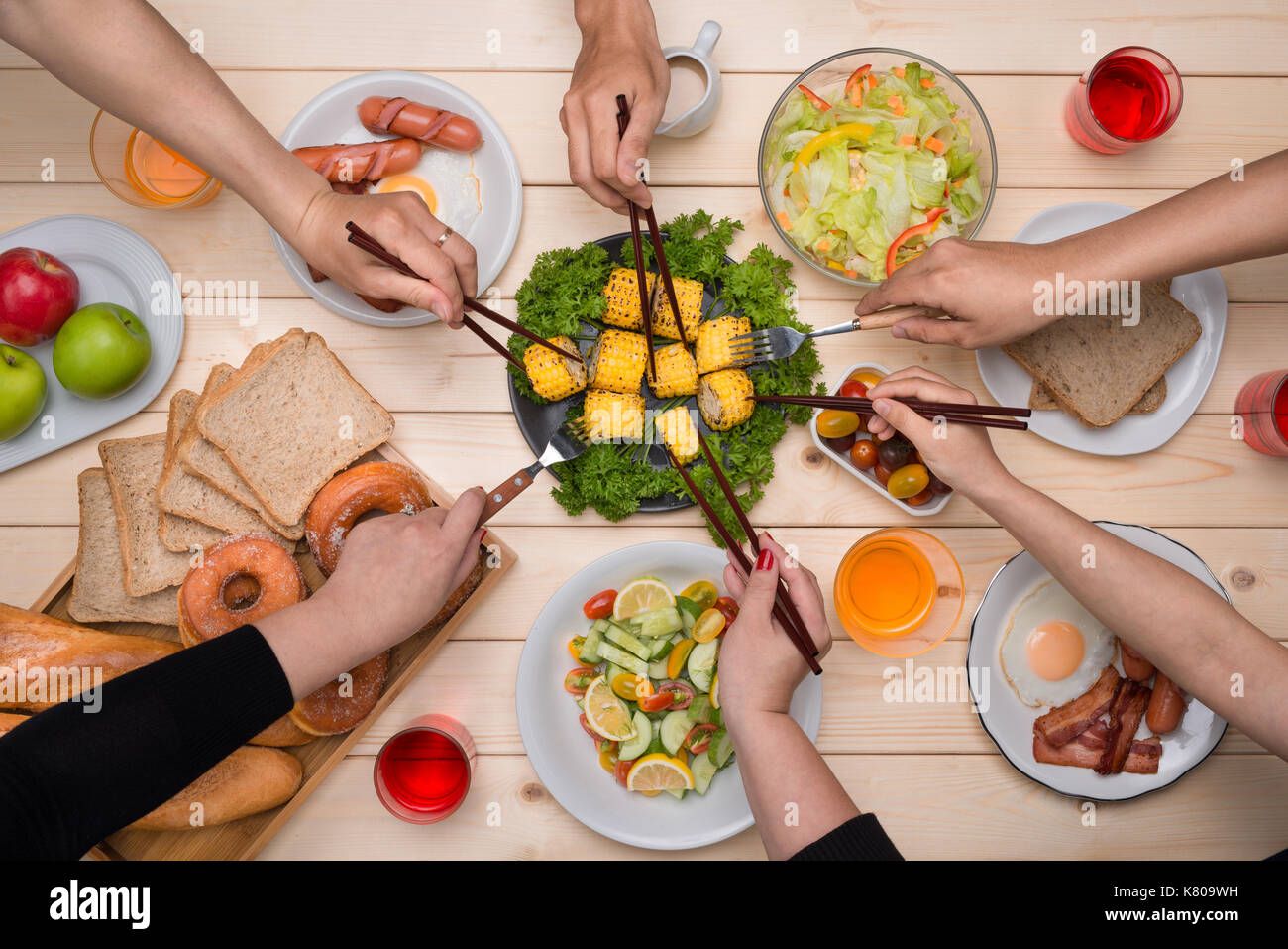 Enjoying dinner with friends. Top view of group of people having dinner ...