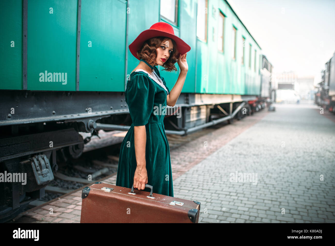 Young old-fashioned woman travels on retro train. Old locomotive ...