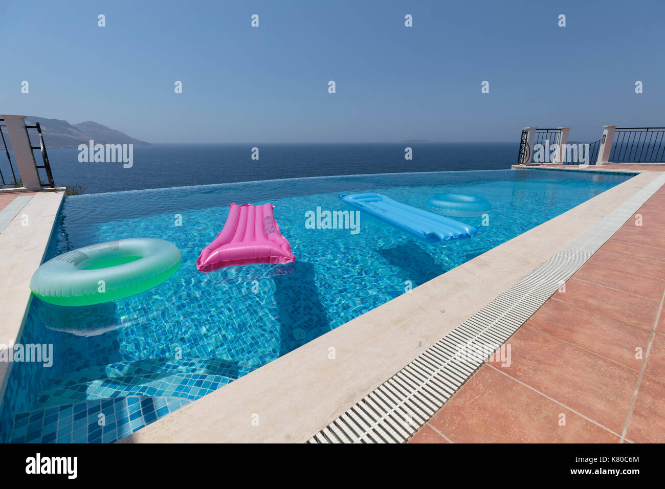 An array of lie lows and inflatable rings in a pool Stock Photo - Alamy