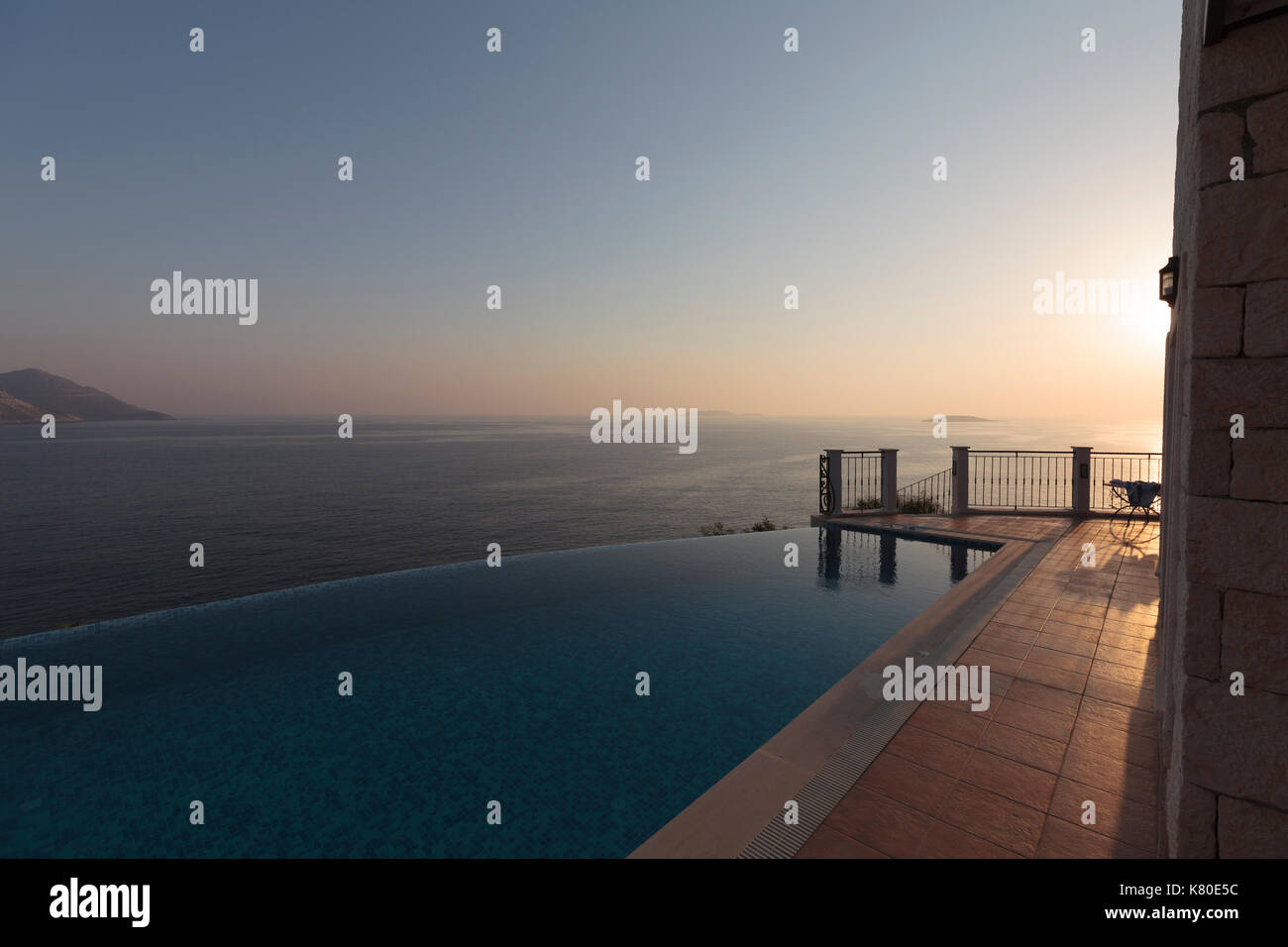 View into distance across infinity pool with lie lows and rings and sun ...