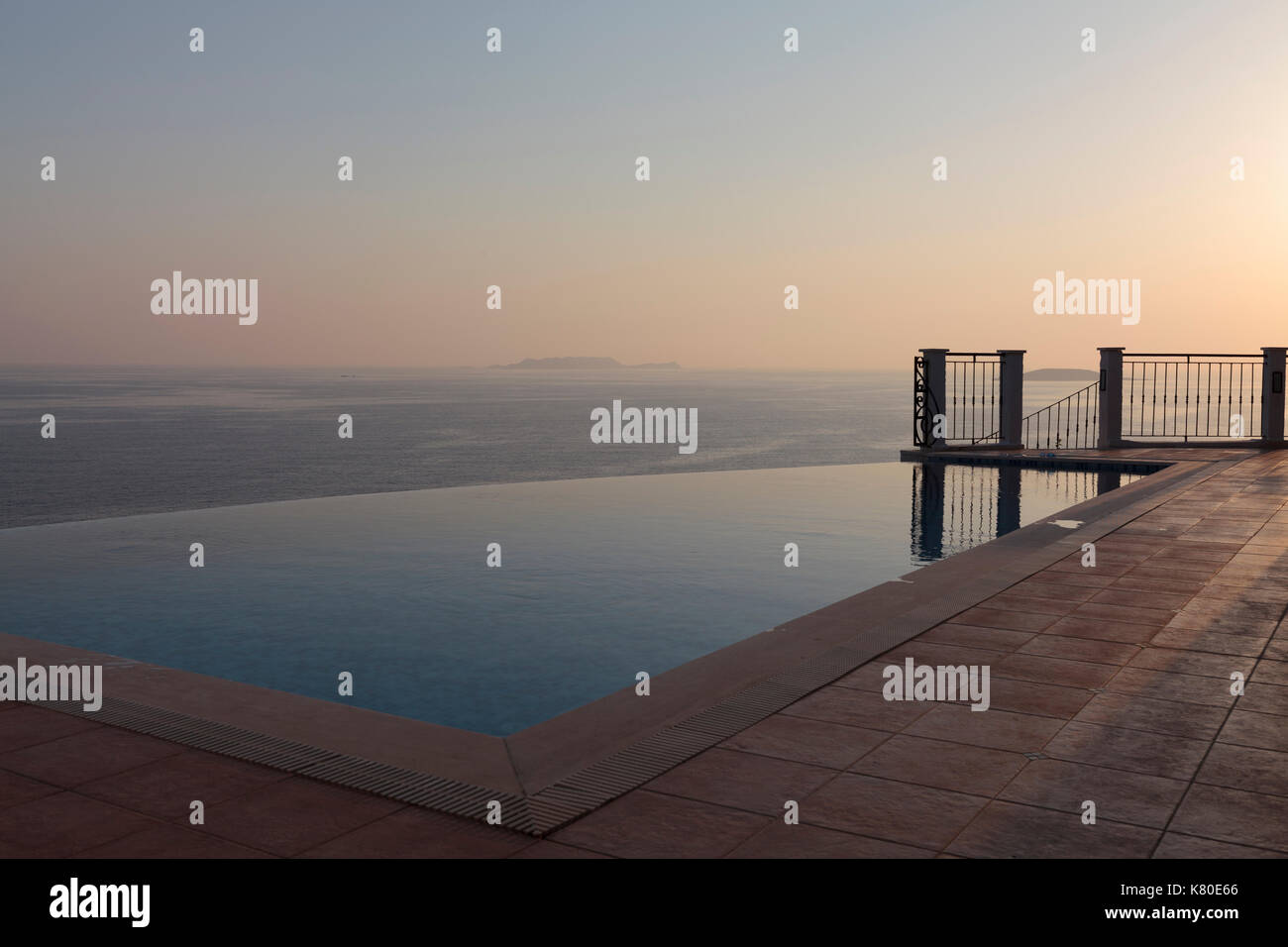 View into distance across infinity pool with lie lows and rings and sun ...
