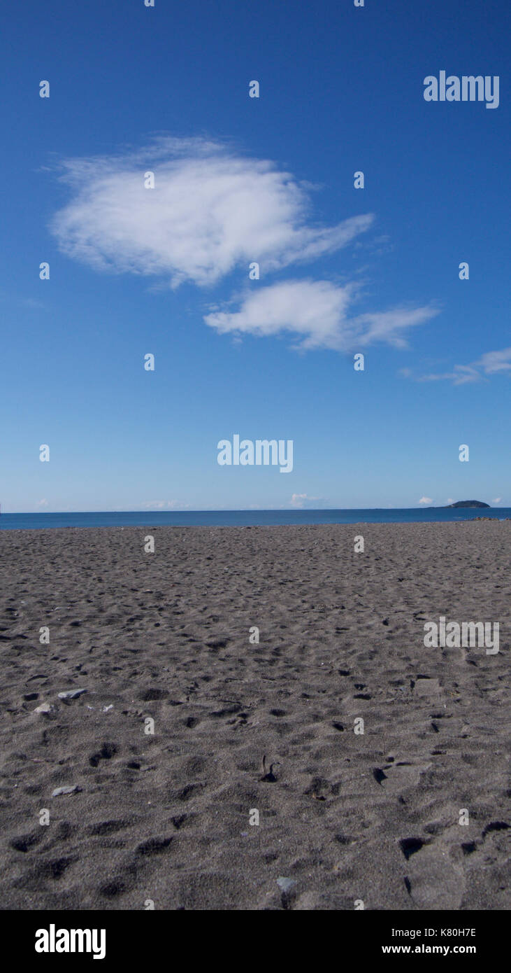 Empty beach with blue sky and clouds showing a distant horizon Stock ...