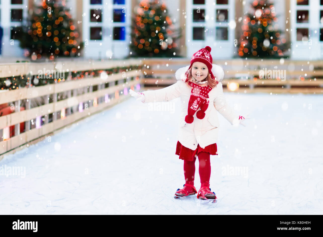 Kids ice skating in winter park rink. Children ice skate on Christmas ...