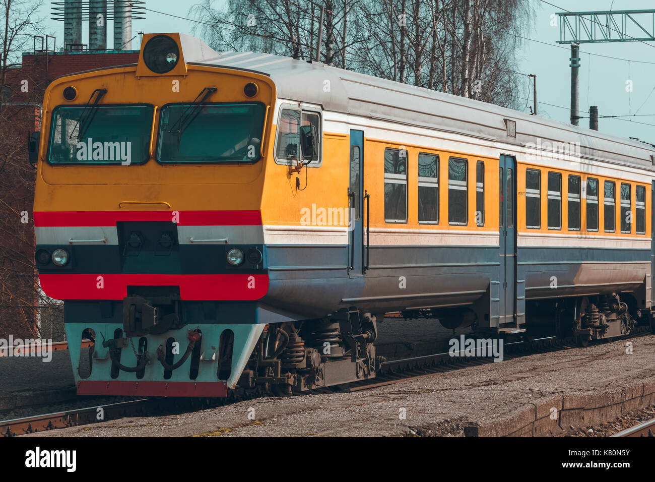 Old yellow passenger diesel train moving at the terminal Stock Photo ...