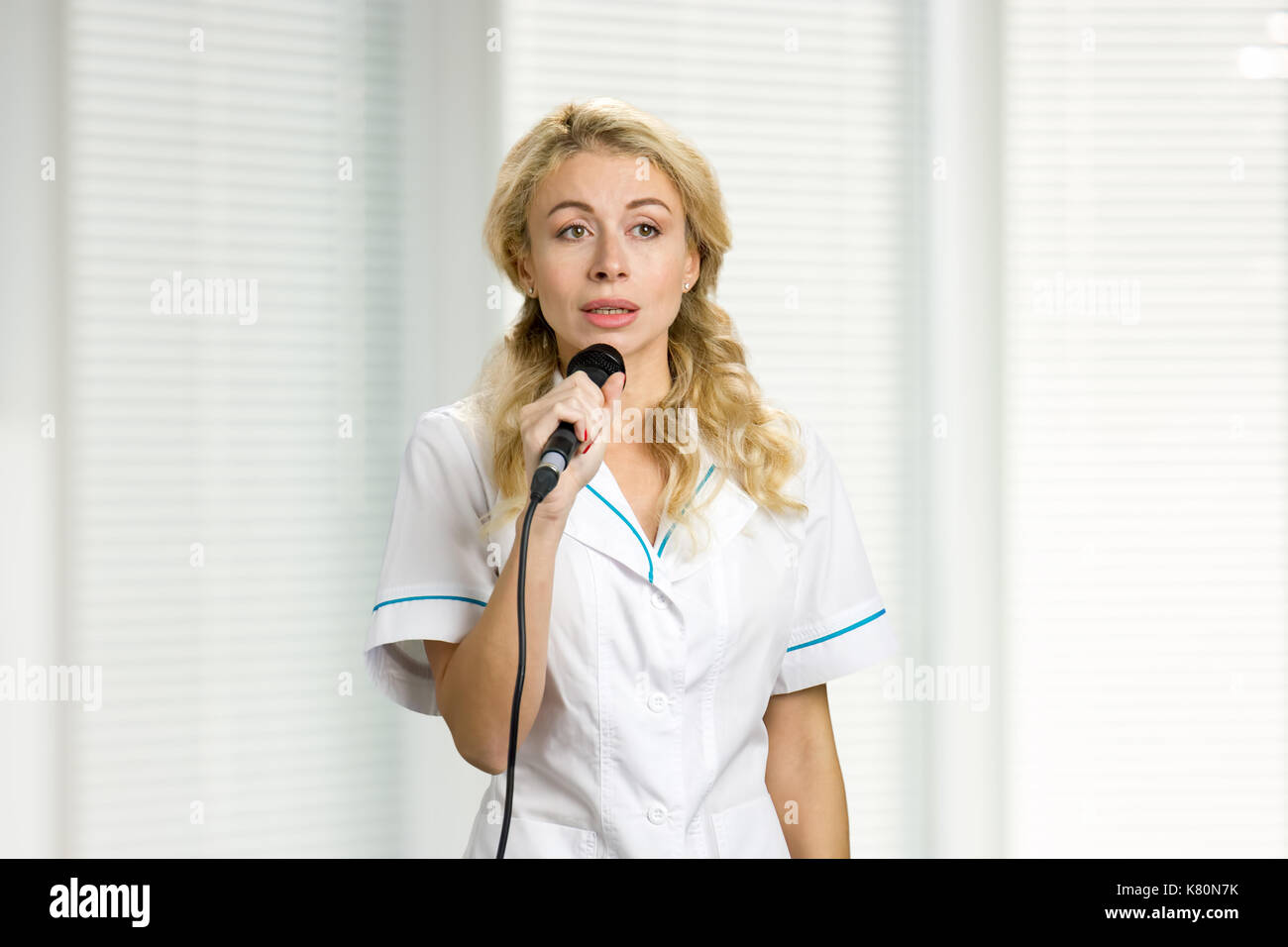 Young woman with microphone Stock Photo - Alamy