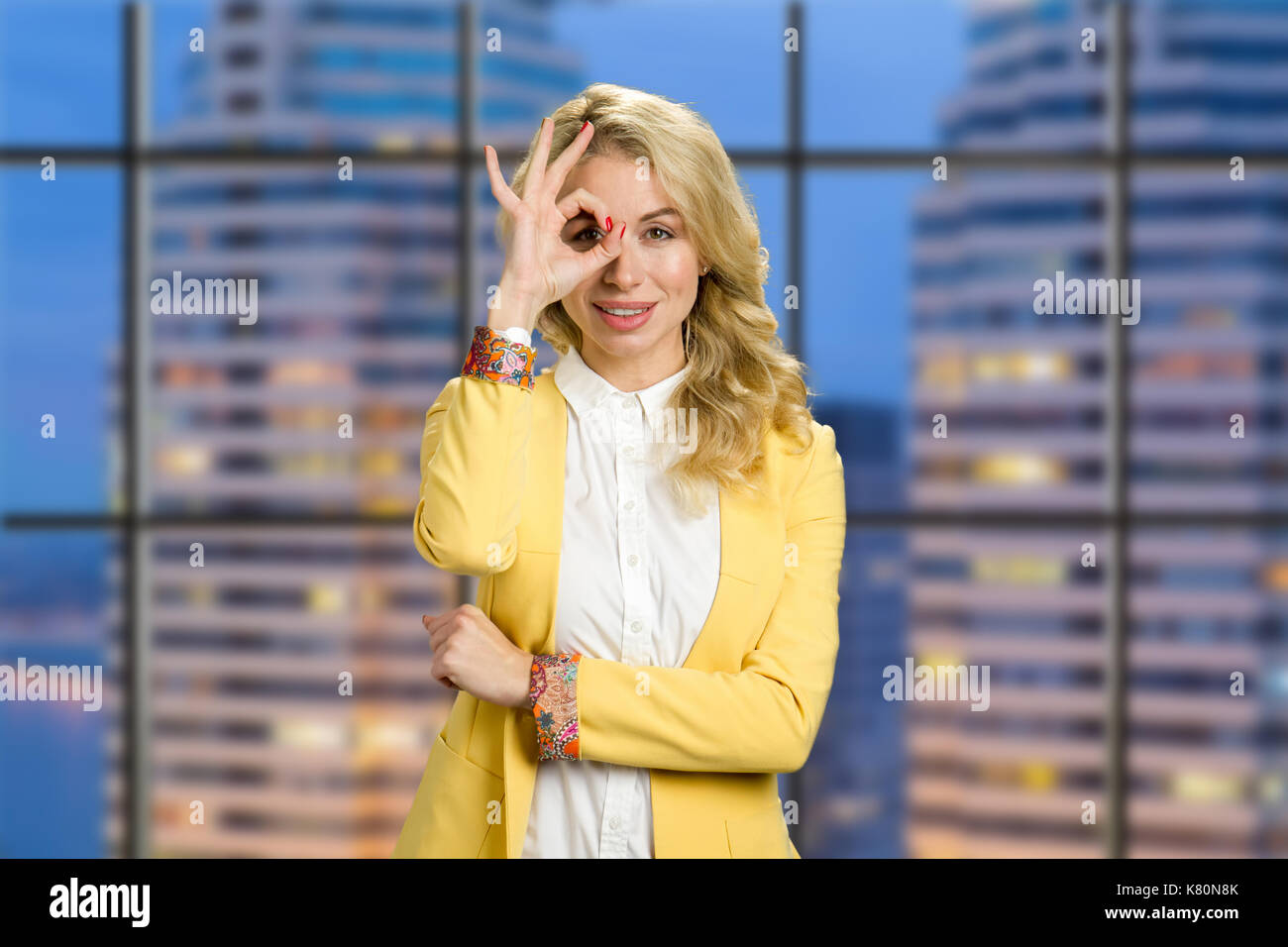 Beautiful woman on evening skyscraper background Stock Photo - Alamy