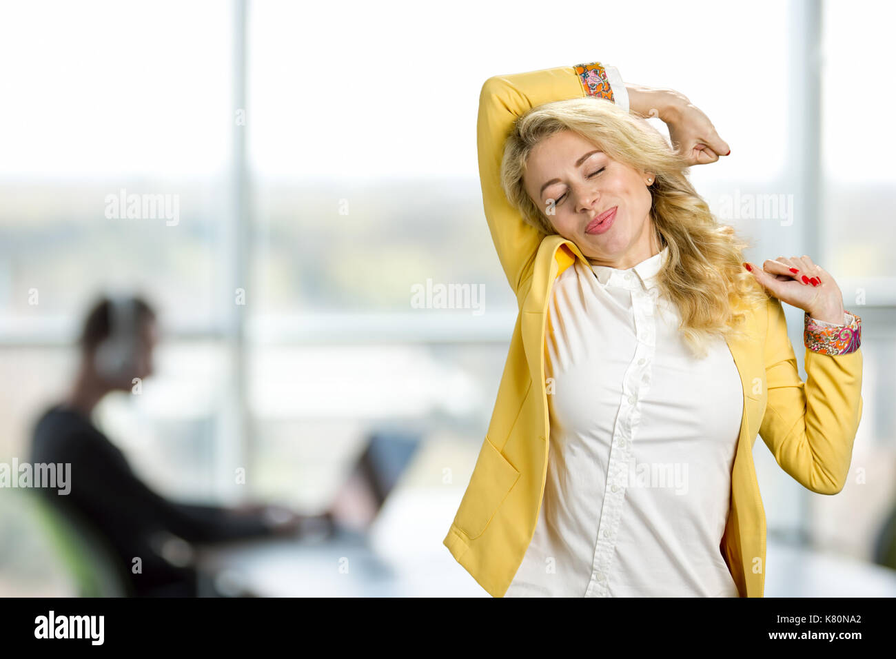 Drowsy girl on office window background Stock Photo - Alamy