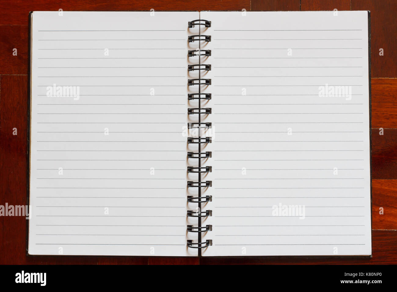 Notebook blank white page. Wooden floor in the background Stock Photo ...