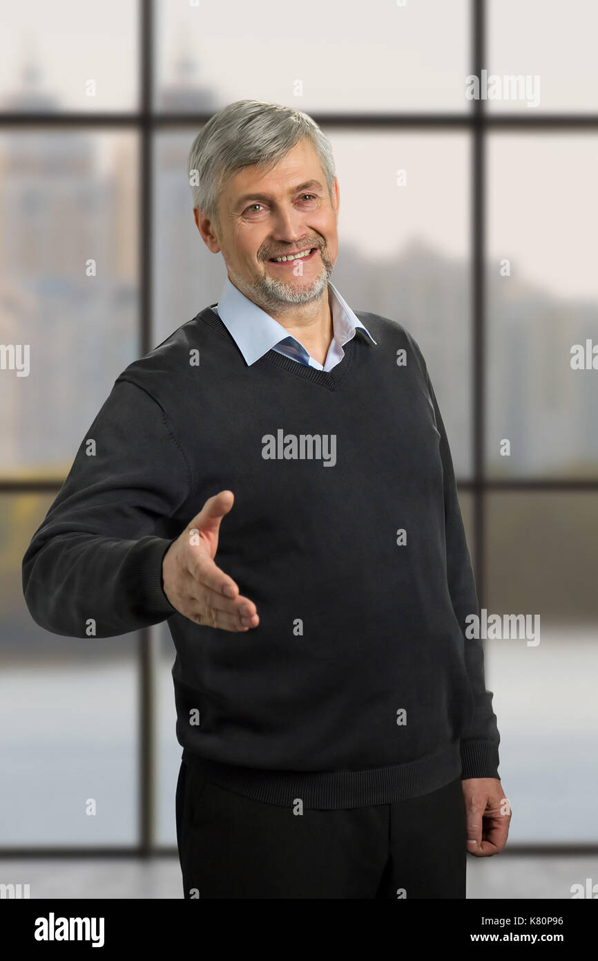 Handsome mature man with greeting gesture Stock Photo - Alamy