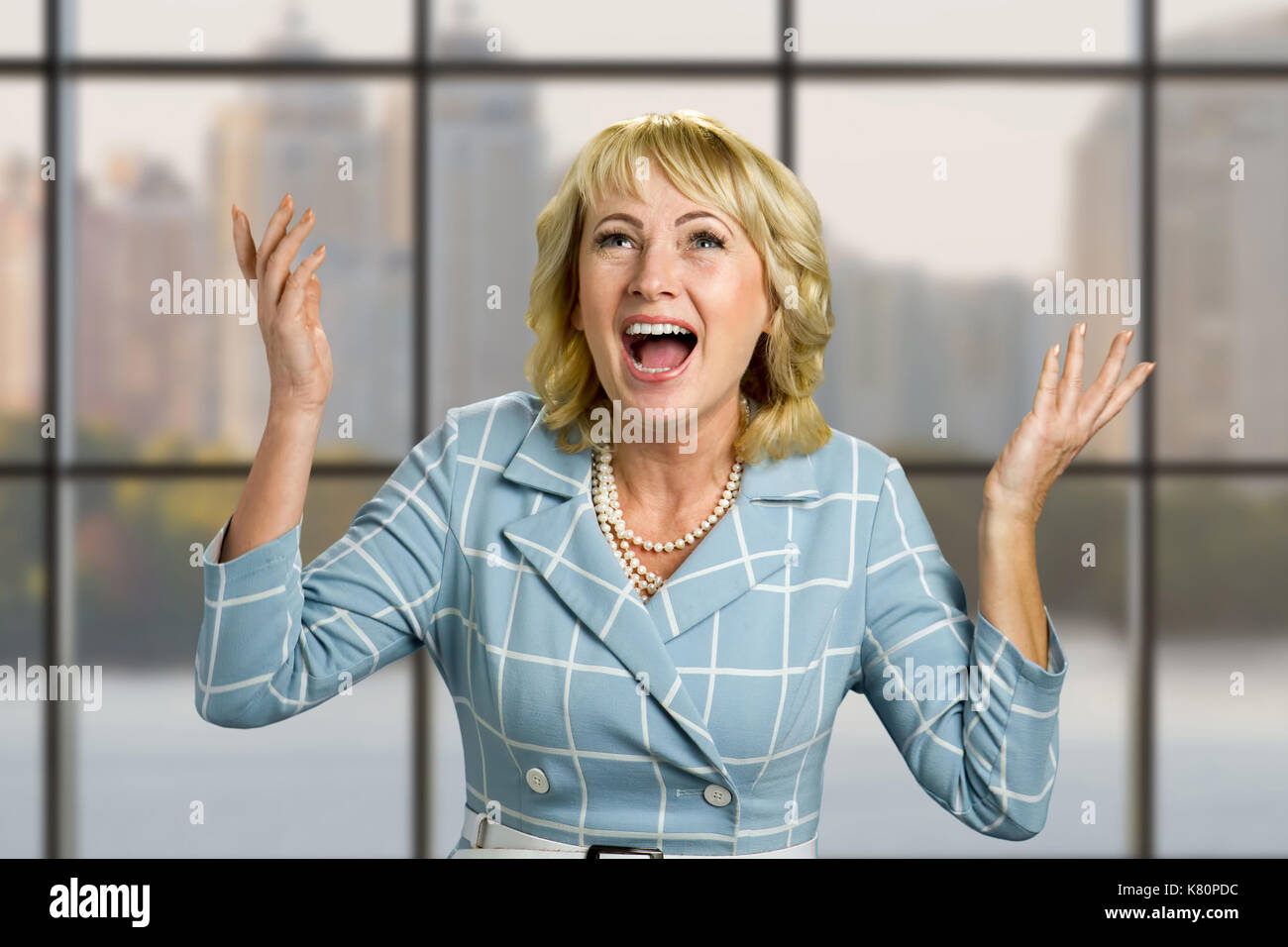 Excited mature woman raised hands Stock Photo - Alamy