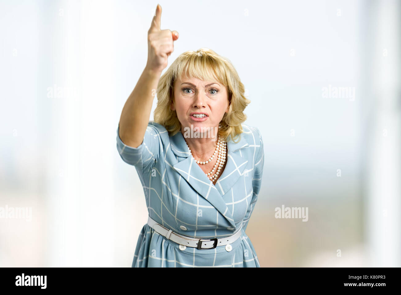 Mature woman raised hand index hi-res stock photography and images - Alamy