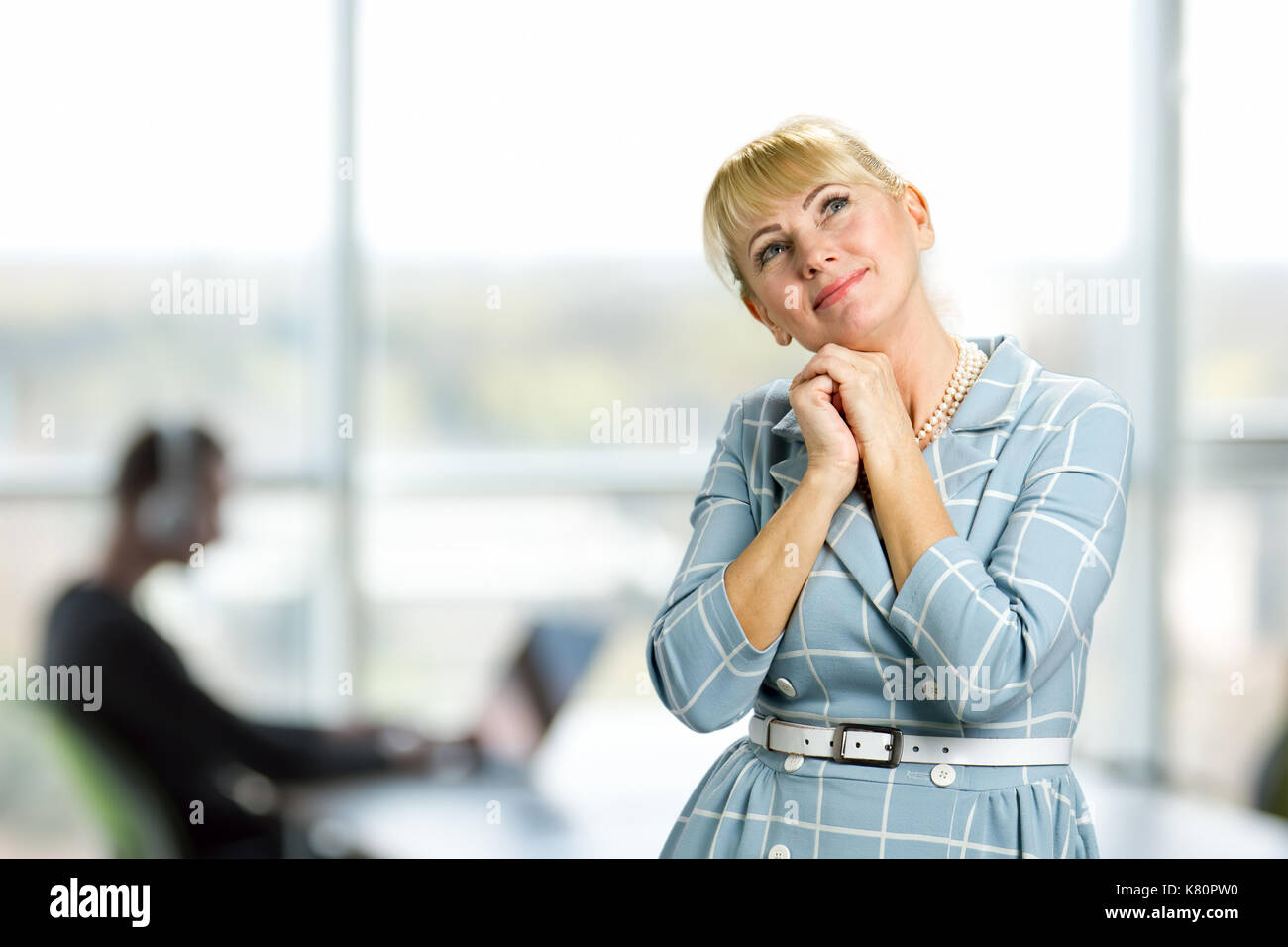 Portrait of thoughtful smiling mature woman Stock Photo - Alamy