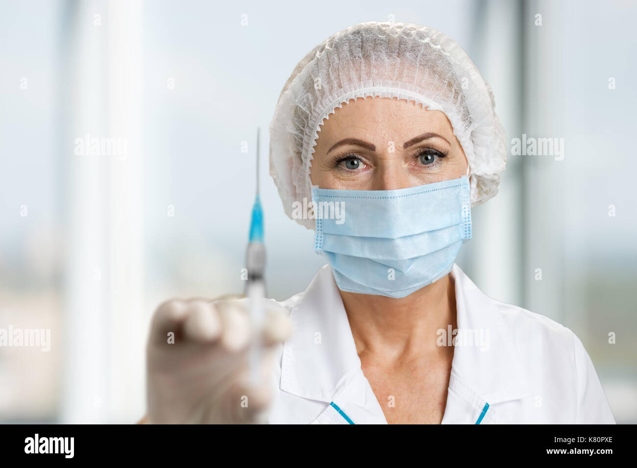 Professional nurse holding syringe with injection Stock Photo - Alamy