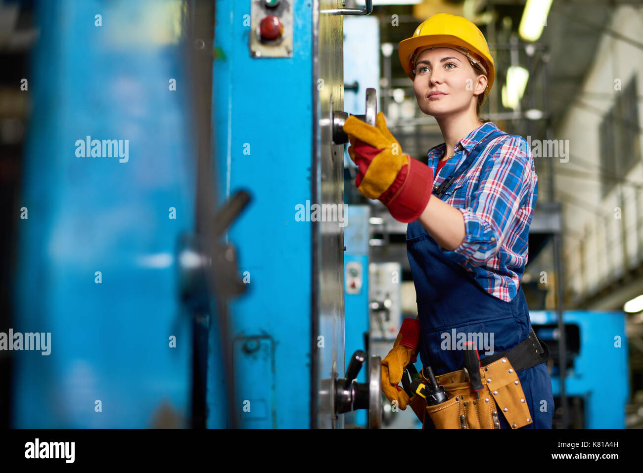 Young Machine Operator Concentrated on Work Stock Photo - Alamy