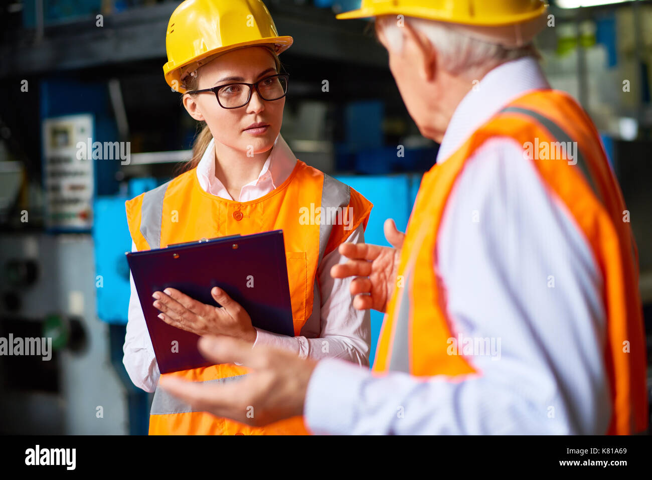 Productive Discussion of Factory Workers Stock Photo - Alamy