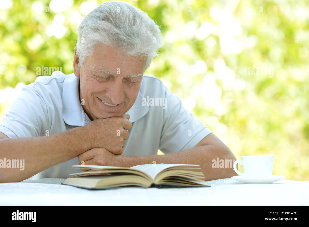 man reading interesting book Stock Photo - Alamy