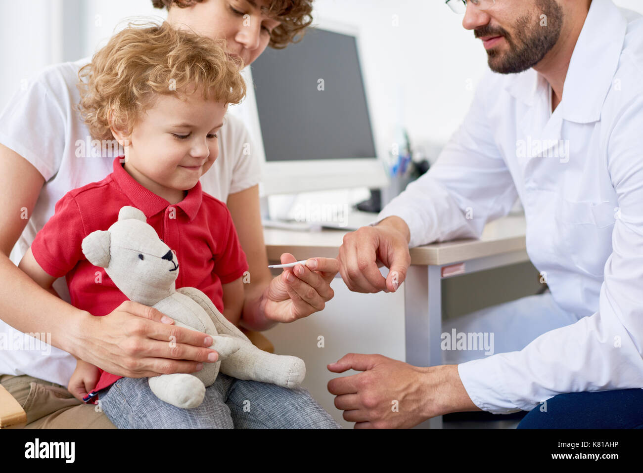 Checking Temperature of Little Son Stock Photo - Alamy