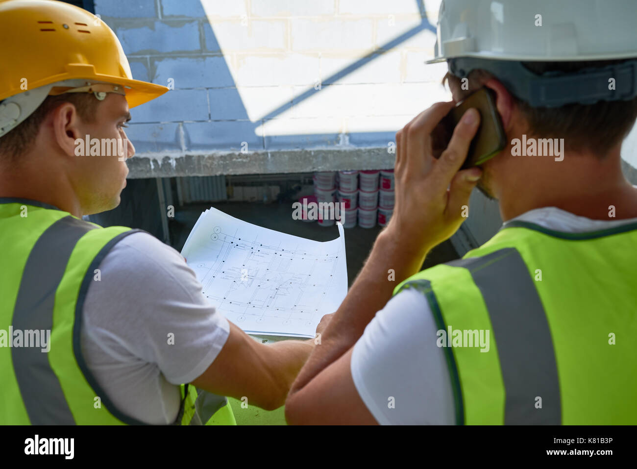 Discussing Floor Plan with Colleague Stock Photo - Alamy