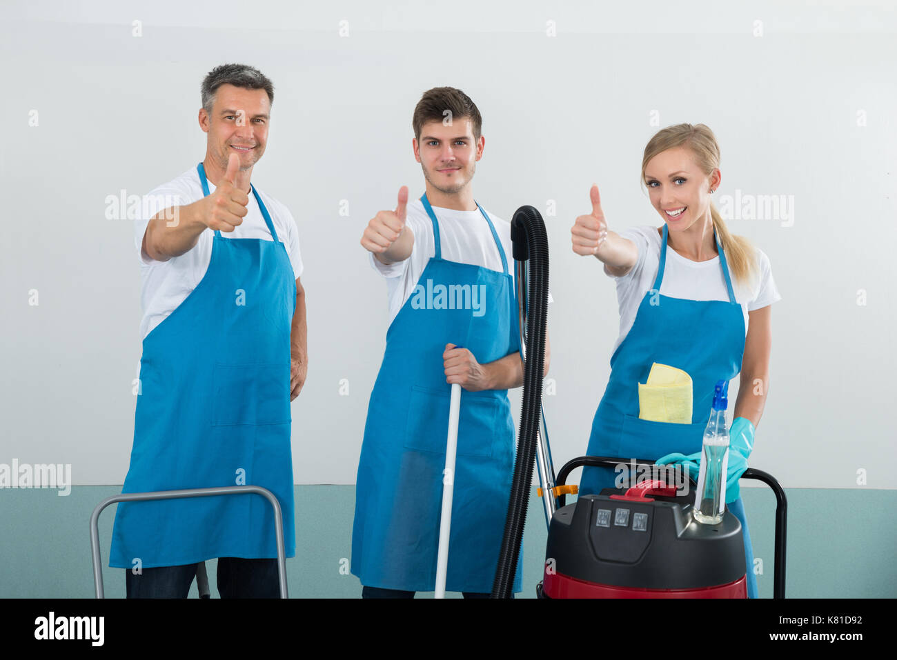 Group Of Happy Janitors With Cleaning Equipments Showing Thumb Up Sign ...