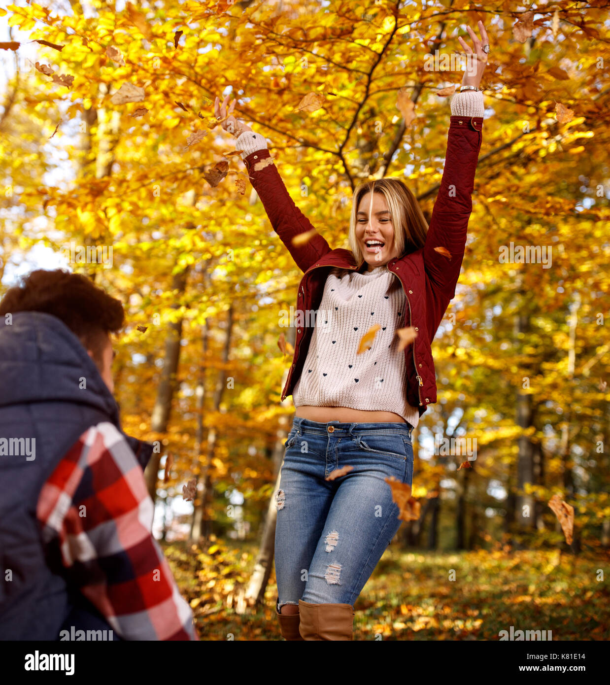 fun, love, relationship and people – young woman throwing fall leaves ...