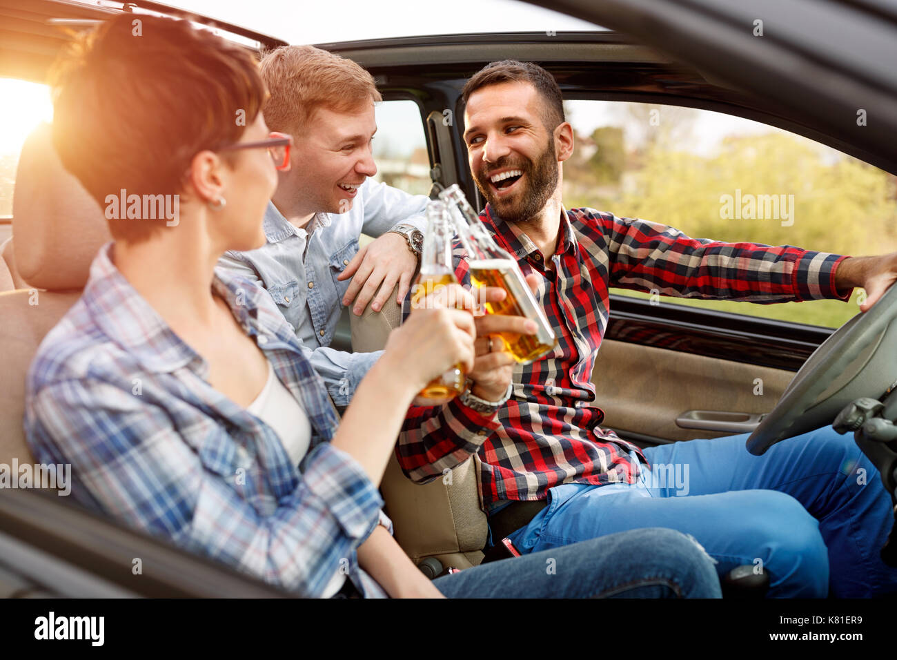 Group of smiling friends having fun in the car on road trip Stock Photo ...
