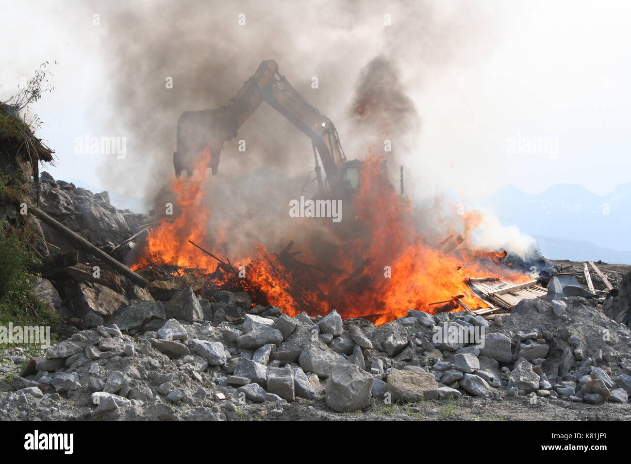 Excavator trying to put out a fire Stock Photo - Alamy