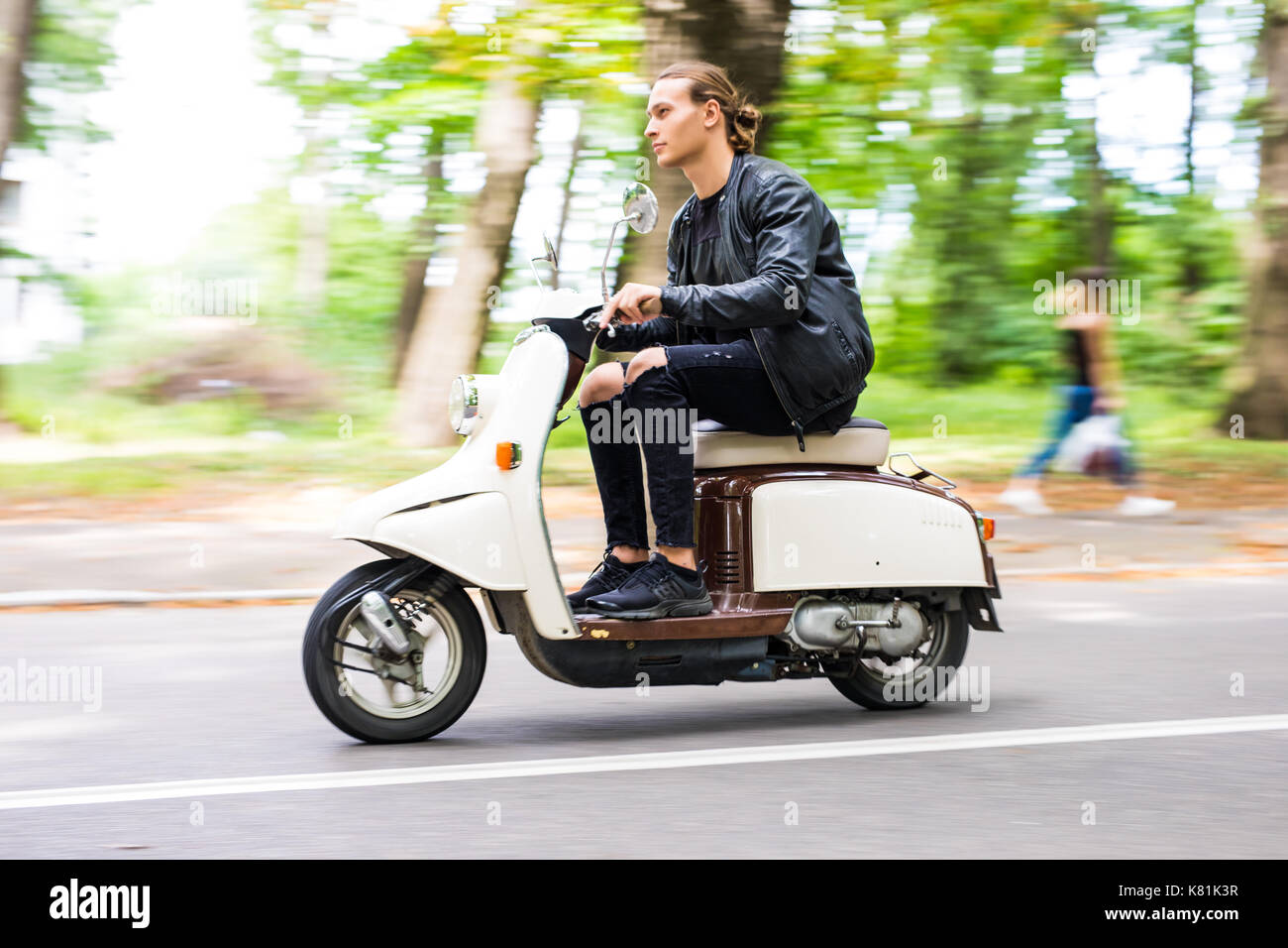Side view of a handsome man riding a motorbike Stock Photo - Alamy