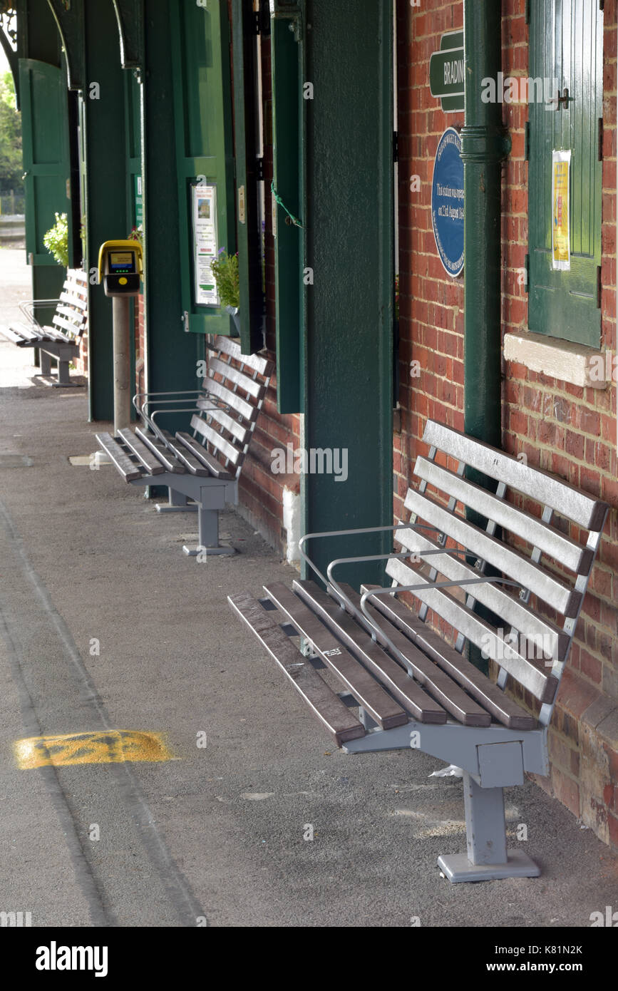 some benches on a station platform painted green in southern railway ...