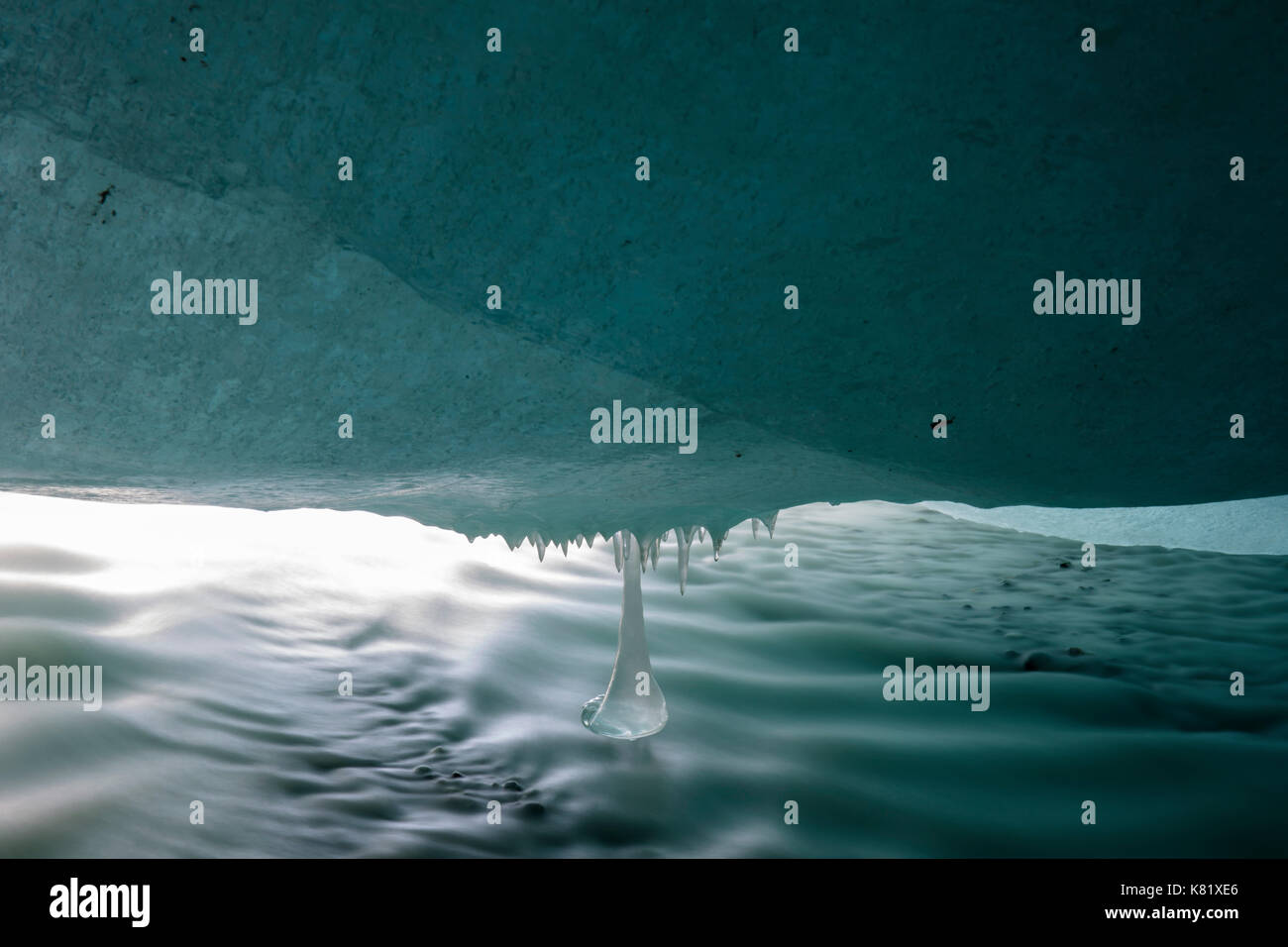 Glacier stream flows under ice cover from Glacier Gate, Zinal Glacier ...