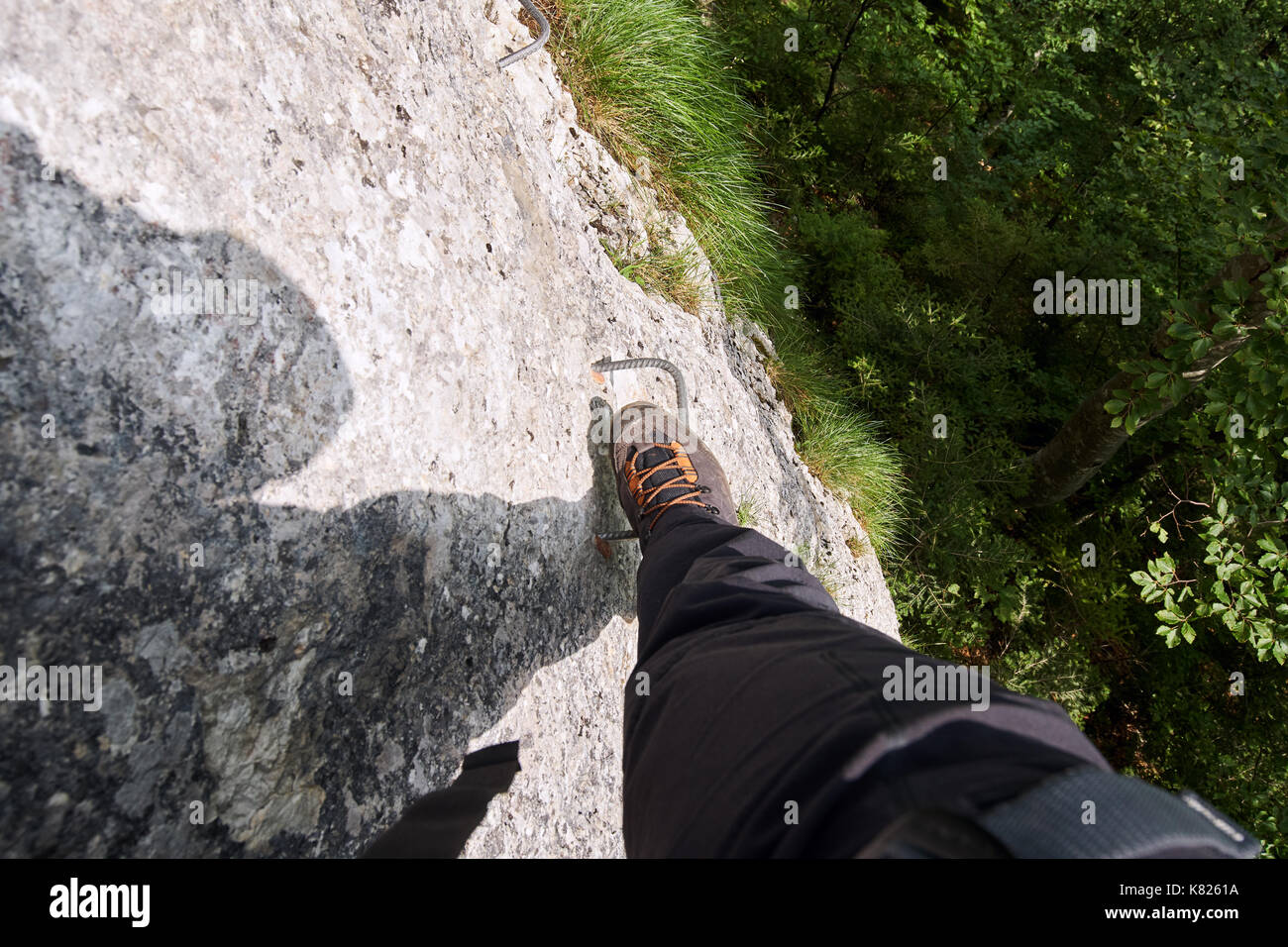The leg of a mountaineer climbing via ferrata route Stock Photo - Alamy