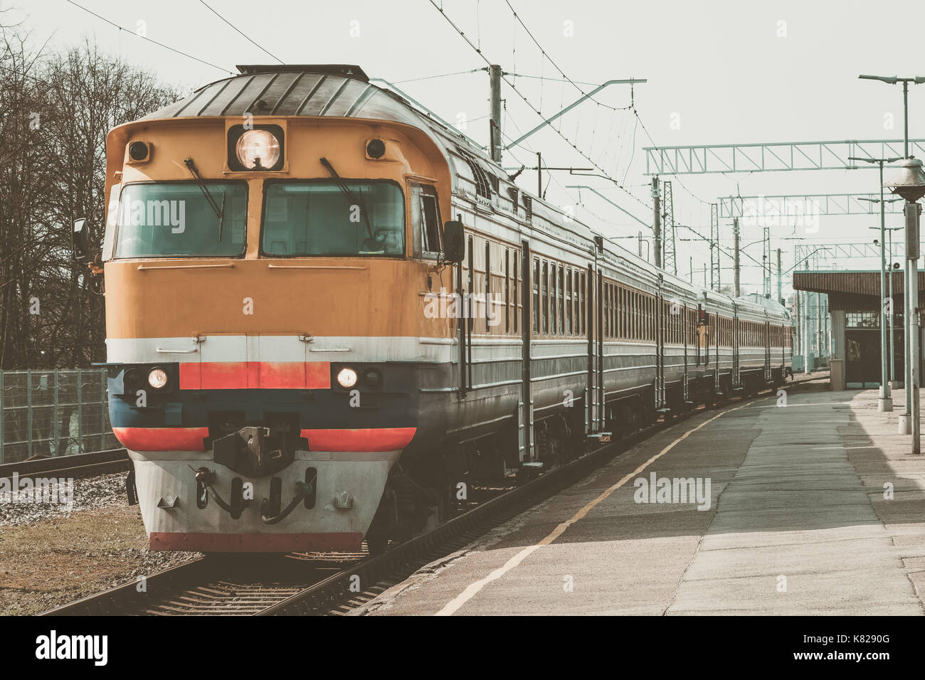 Old yellow passenger diesel train moving at the terminal Stock Photo ...