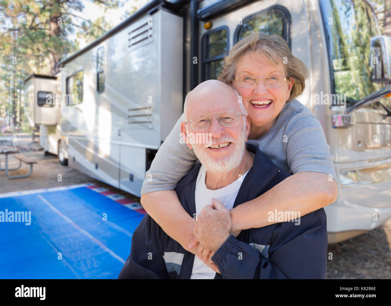 Senior Couple In Front of Their Beautiful RV At The Campground Stock ...