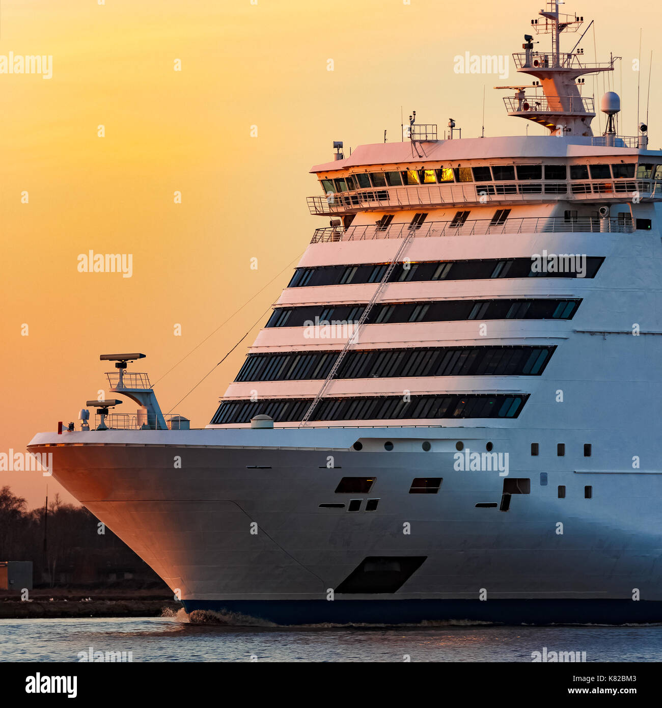 White passenger ship moving against the orange sunset sky Stock Photo ...