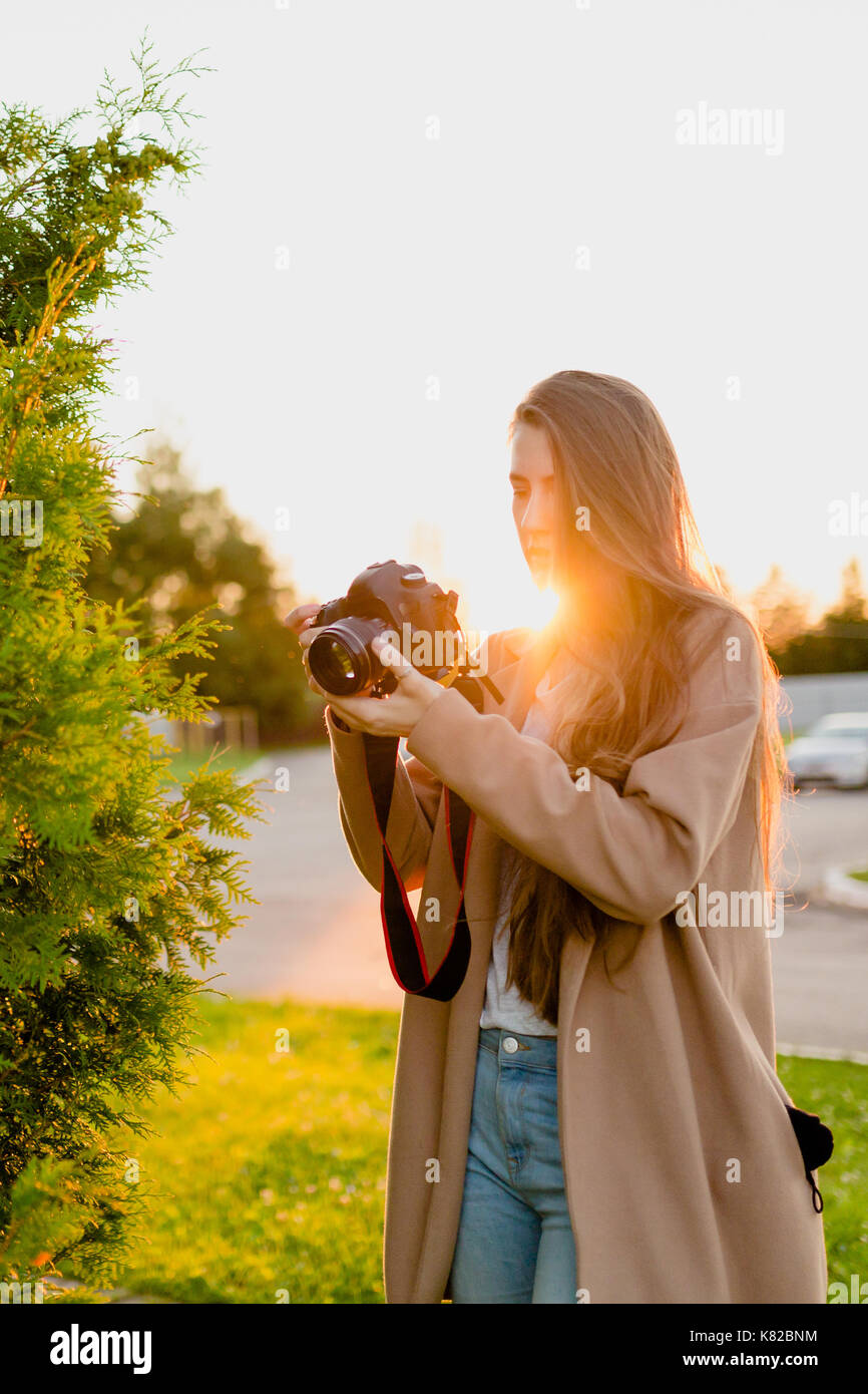 Woman photographer watching photos Stock Photo - Alamy