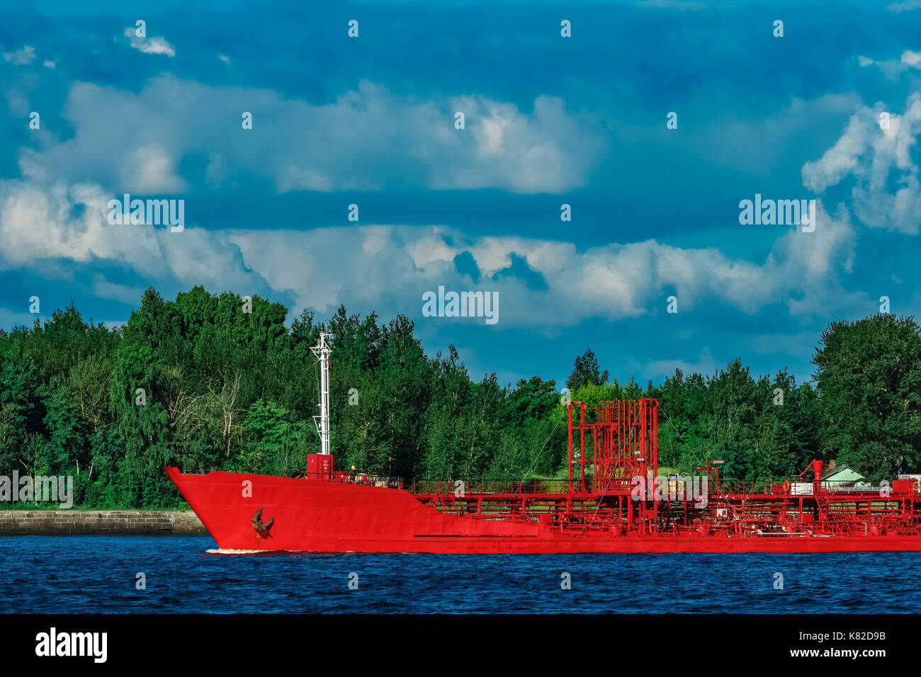 Red cargo tanker ship moving by the river Stock Photo - Alamy