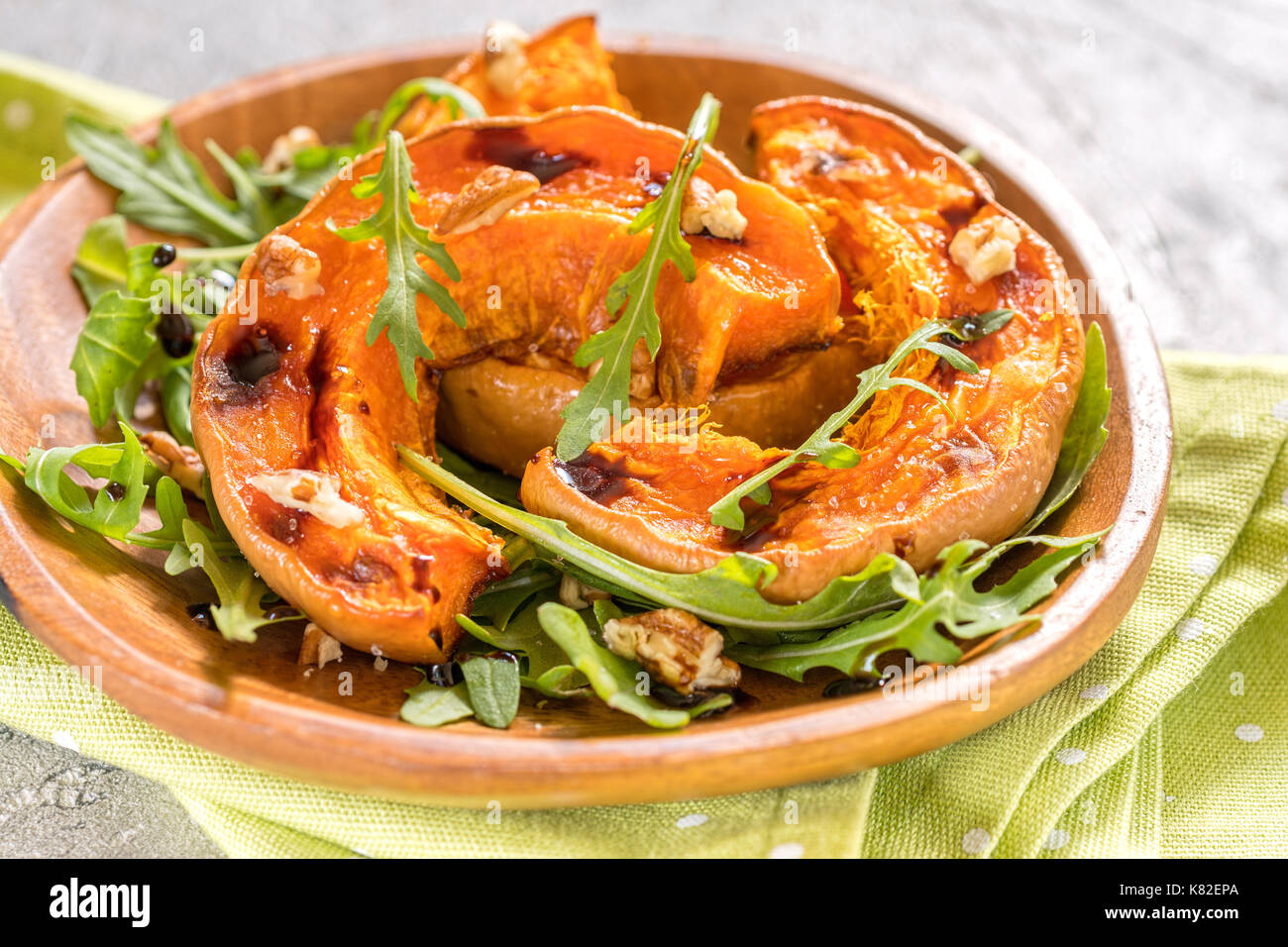 Roasted pumpkin with pecan nuts and arugula Stock Photo - Alamy