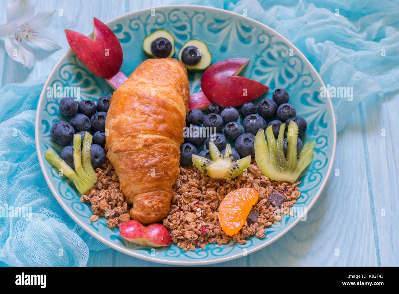 Lobster Croissant with berries for kids breakfast Stock Photo - Alamy