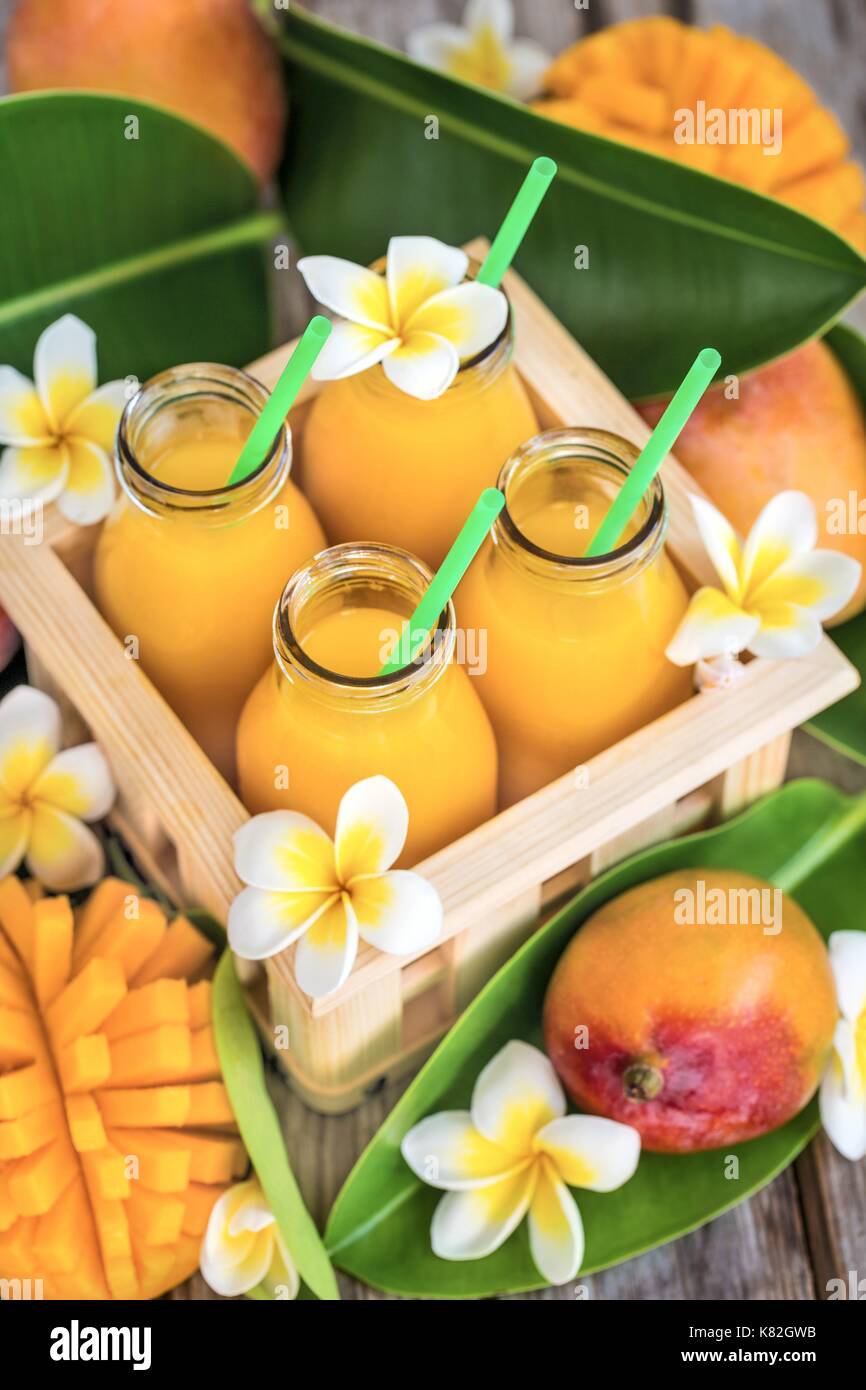 Fresh mango juice in small bottles in wooden box Stock Photo - Alamy