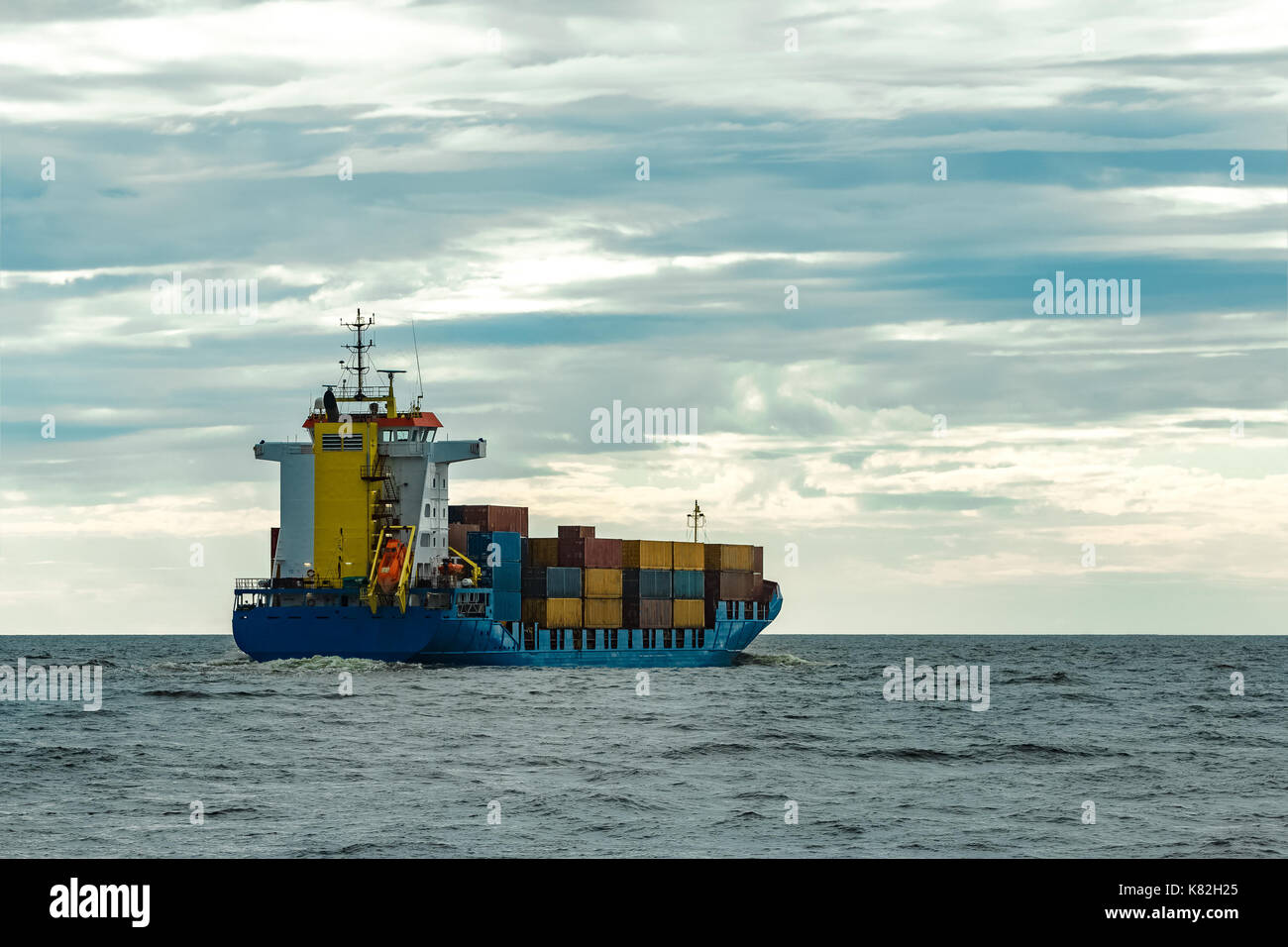 Blue cargo container ship fully loaded underway Stock Photo - Alamy