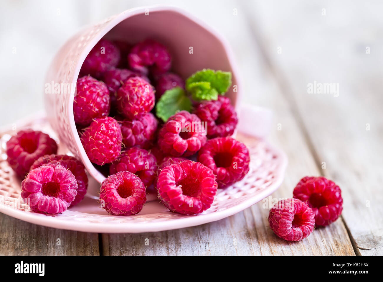 Fresh ripe raspberry in small tea cup Stock Photo - Alamy