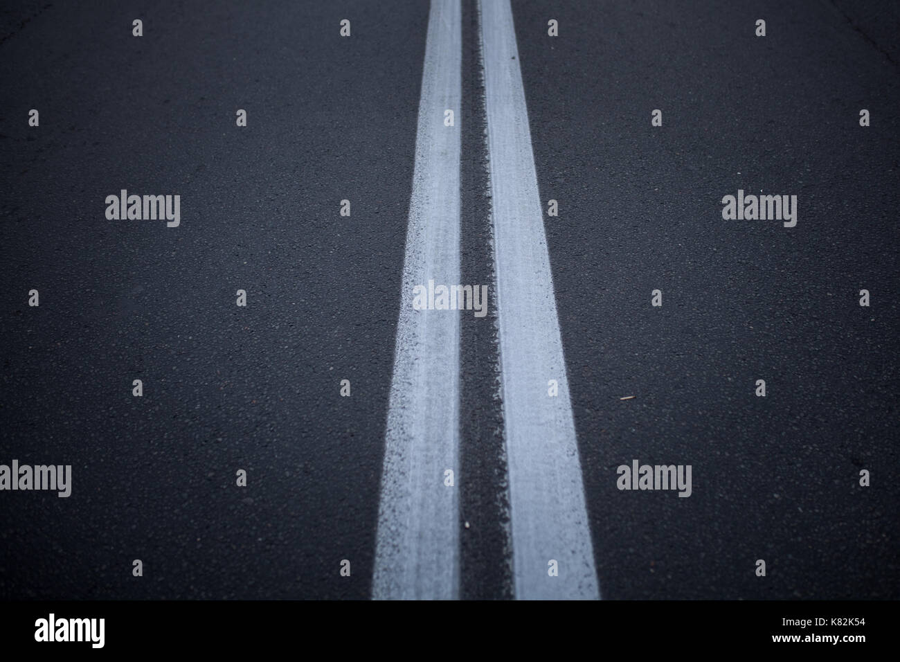 Asphalt road with marking lines white stripes. Two solid lines ...