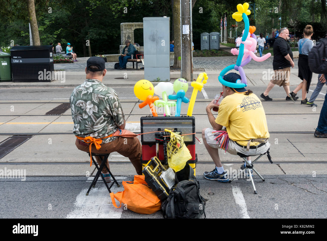 Two men making balloon shapes for charity at the Toronto Beaches Jazz ...